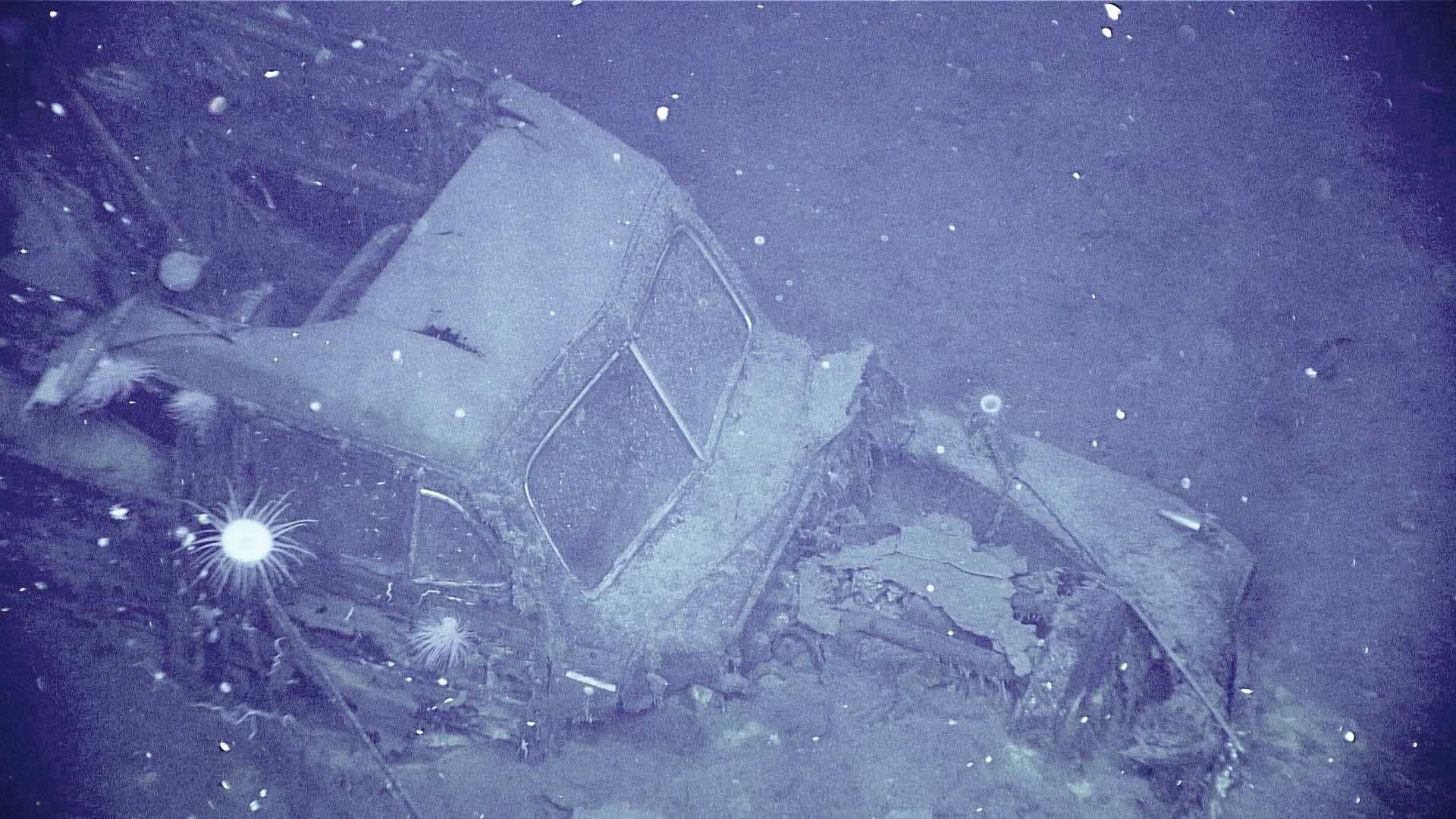 5km-deep dive reveals aircraft, map + mystery car